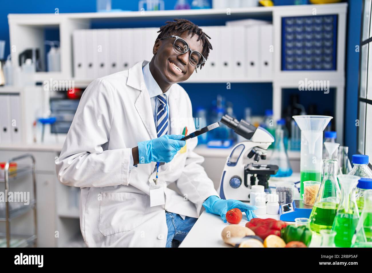 African american man scientist looking tomato using loupe at laboratory Stock Photo - Alamy