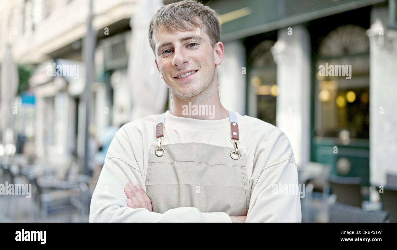 Young caucasian man waiter smiling confident standing with arms crossed ...