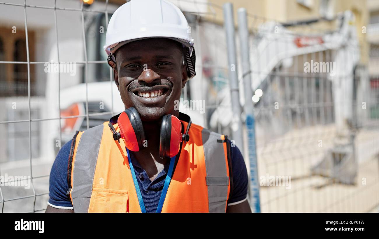 African american man builder smiling confident wearing hardhat at ...