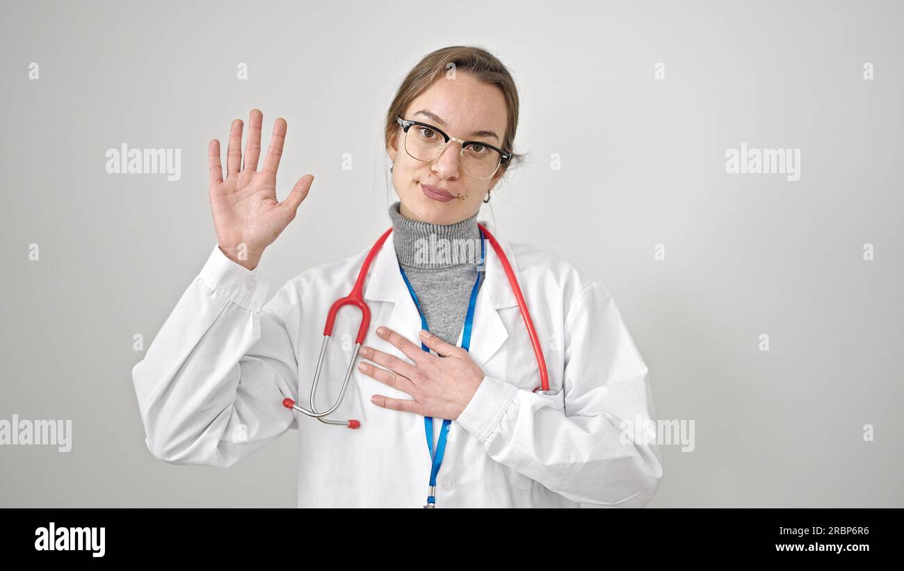 Young caucasian woman doctor making an oath with hand on chest over ...