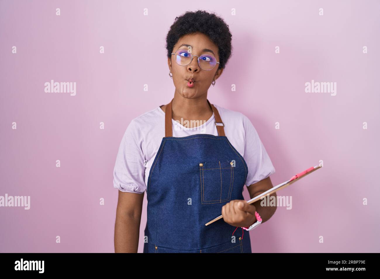 Young african american woman wearing professional waitress apron ...