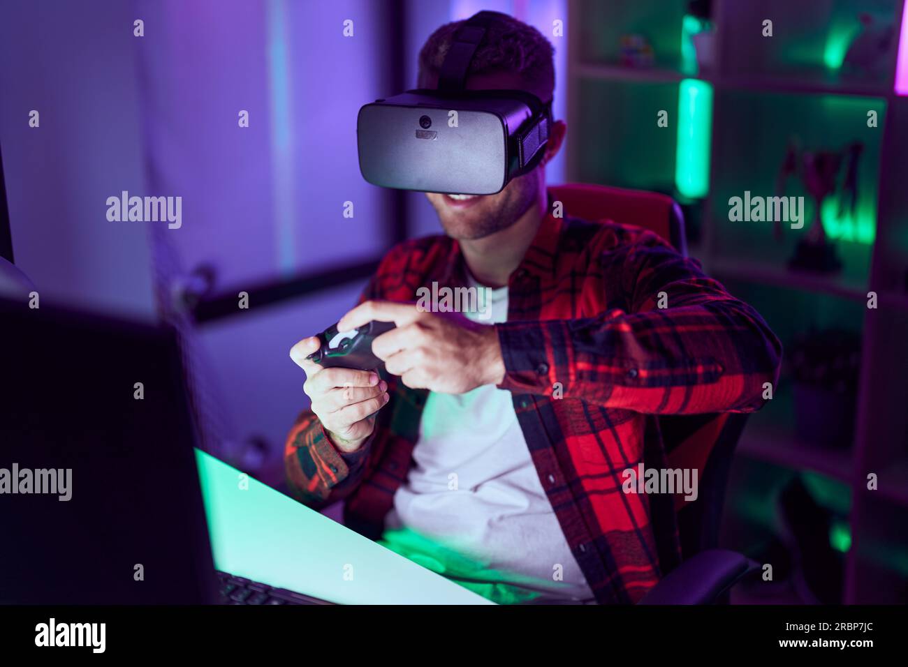 Young caucasian man streamer playing video game using virtual reality ...