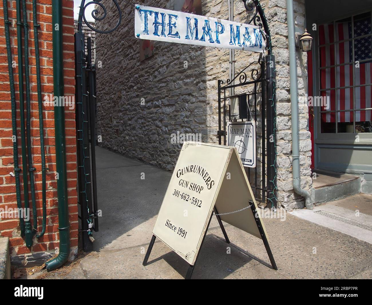 Gun shop and map shop signs on E Patrick Street in Frederick, Maryland ...