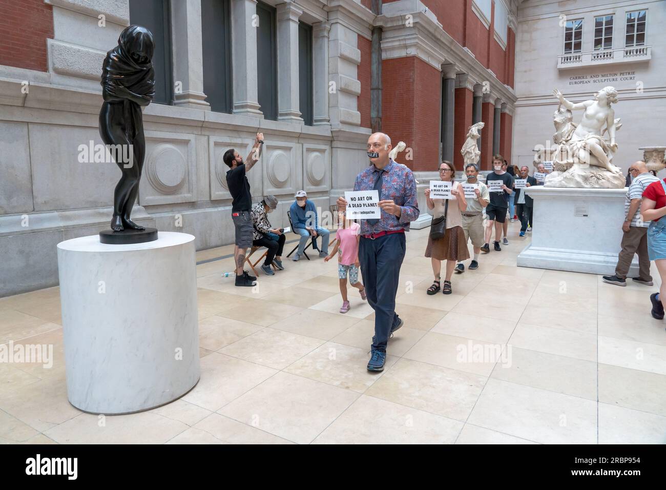 Members of Extinction Rebellion NYC and Rise and Resist with strips of ...