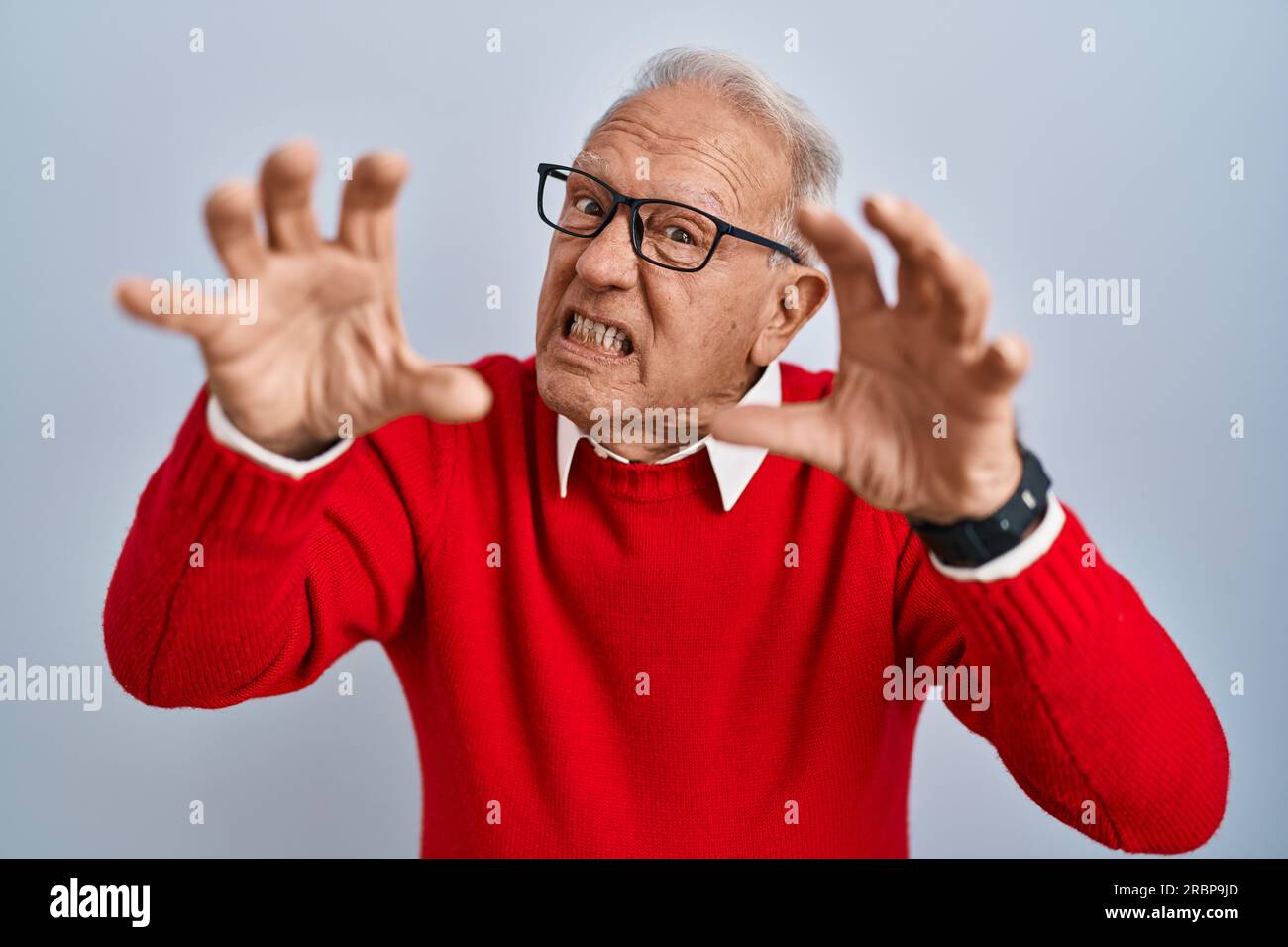 Senior man with grey hair standing over isolated background shouting ...