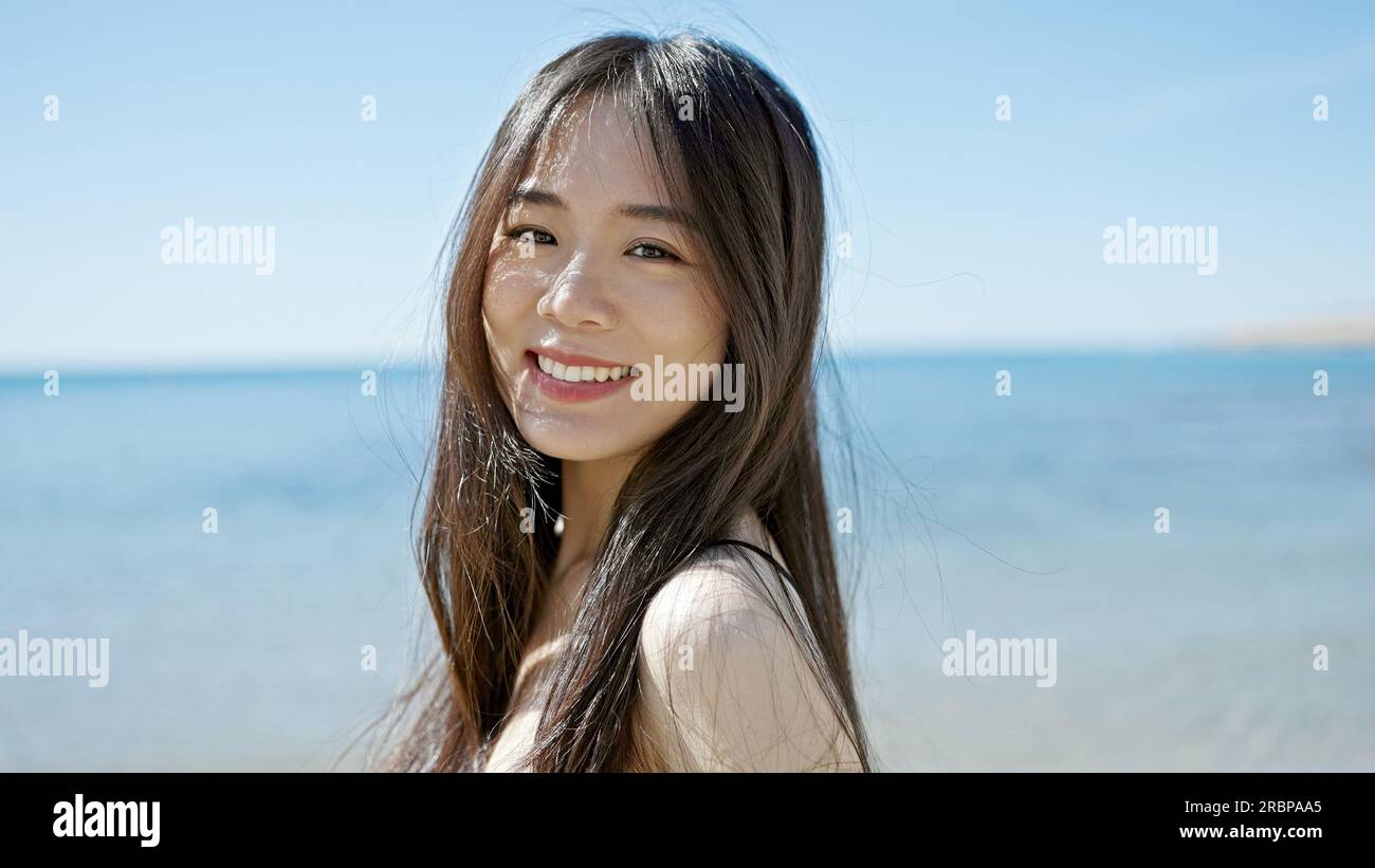 Young chinese woman smiling confident standing at seaside Stock Photo ...