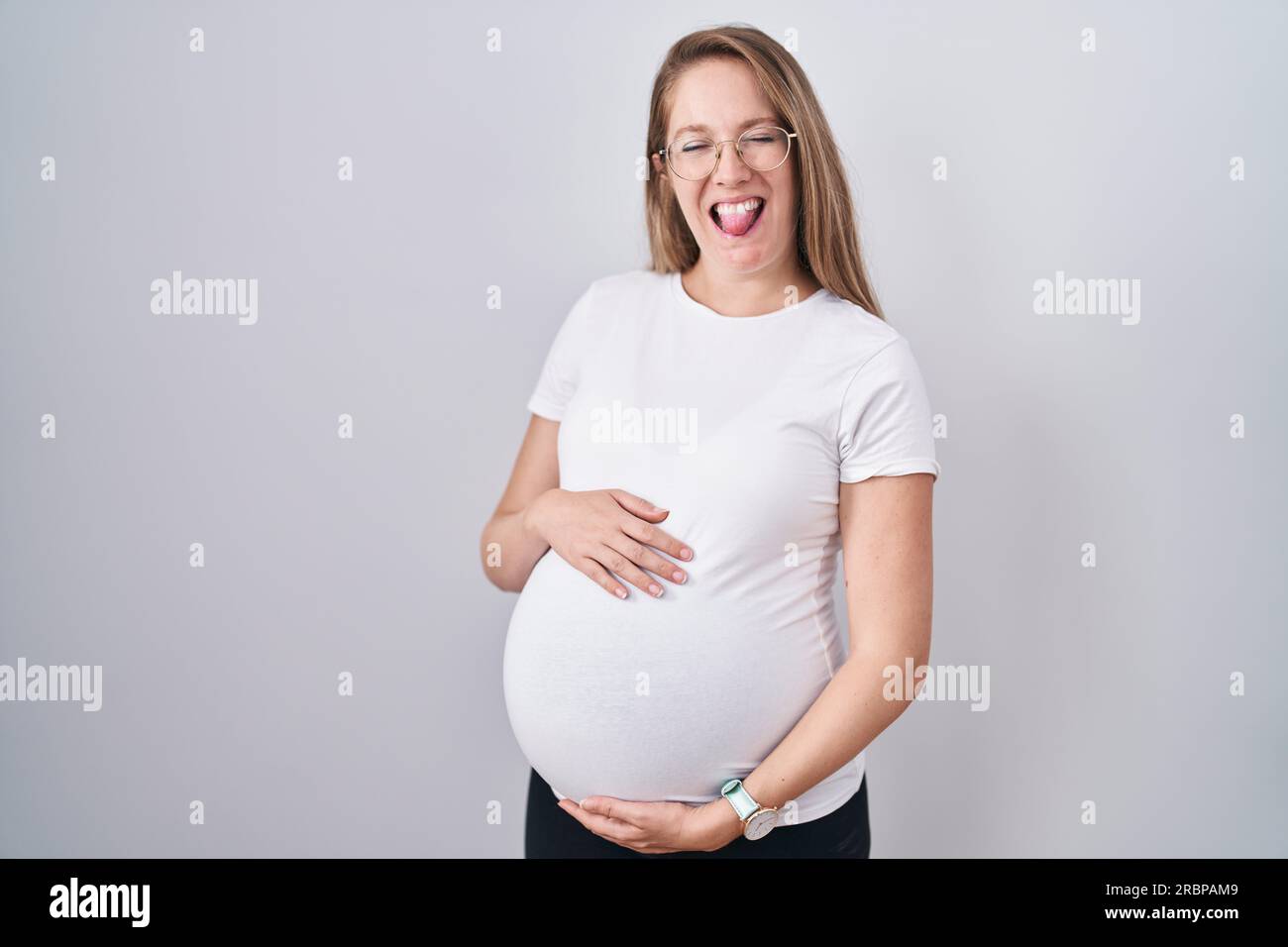 Young pregnant woman expecting a baby, touching pregnant belly sticking ...