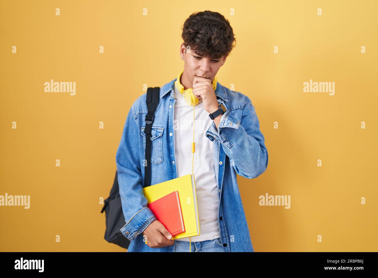 Hispanic teenager wearing student backpack and holding books feeling ...