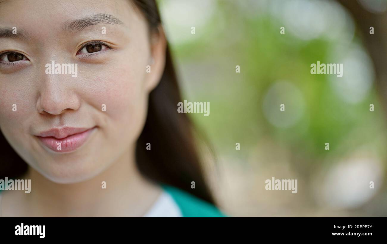 Young chinese woman smiling confident standing at park Stock Photo - Alamy