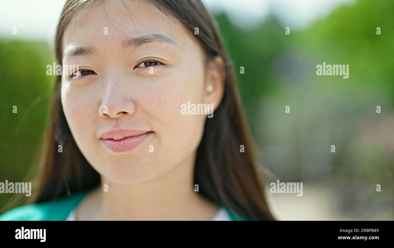 Young chinese woman smiling confident standing at park Stock Photo - Alamy