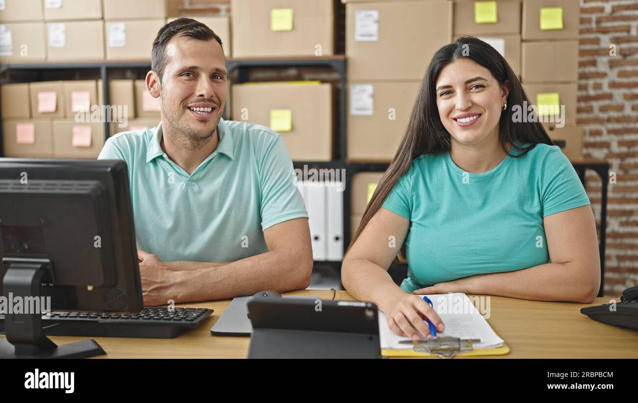 Two coworkers working using computer at ecommerce office Stock Photo ...