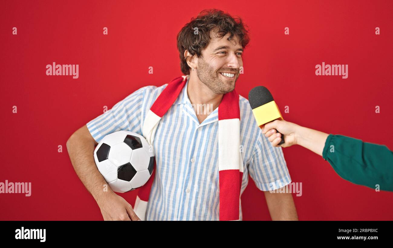Young hispanic man supporting soccer team having interview over ...