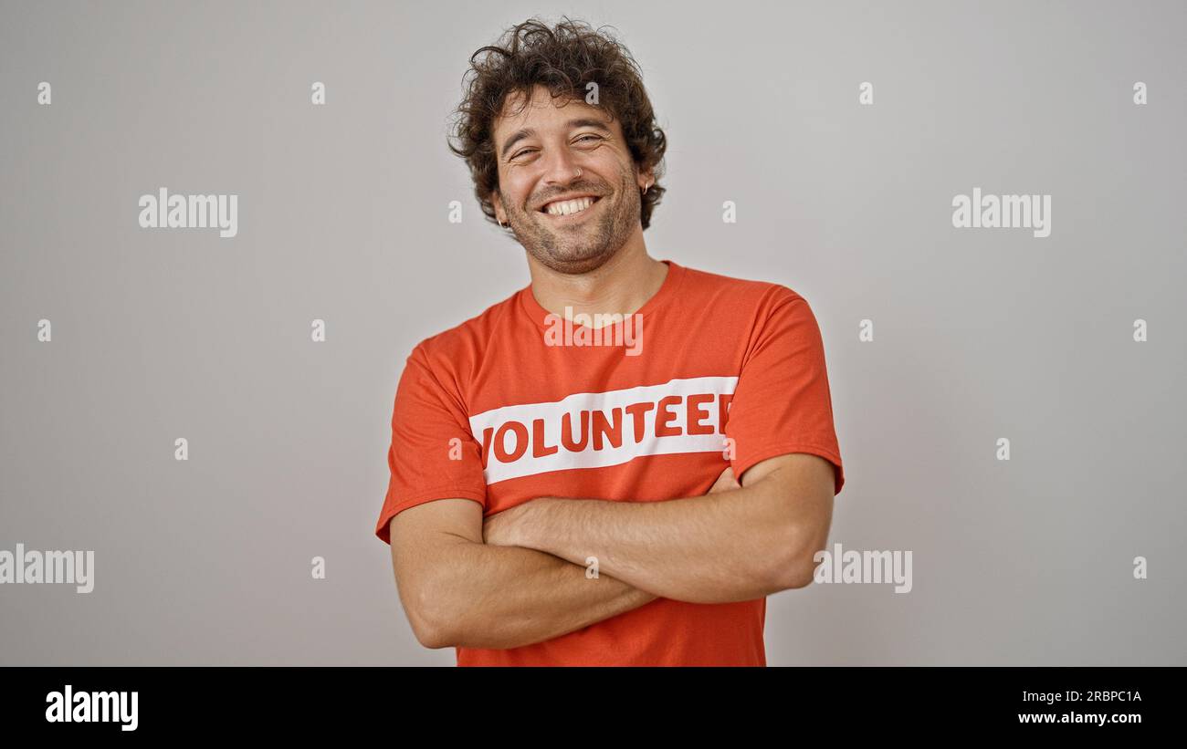 Young hispanic man activist wearing volunteer uniform standing with ...