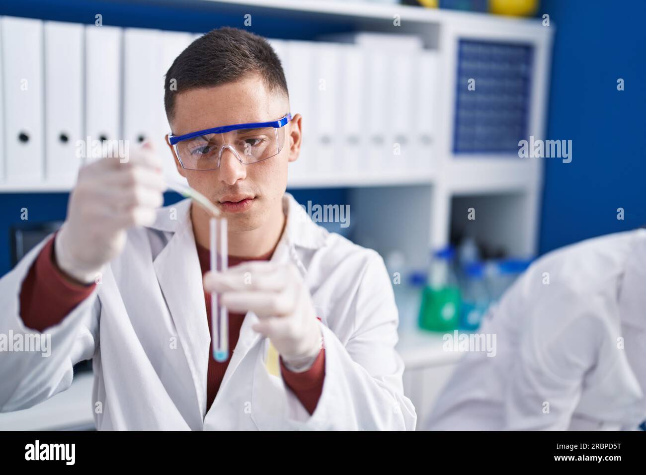 Man and woman scientists measuring liquid at laboratory Stock Photo - Alamy