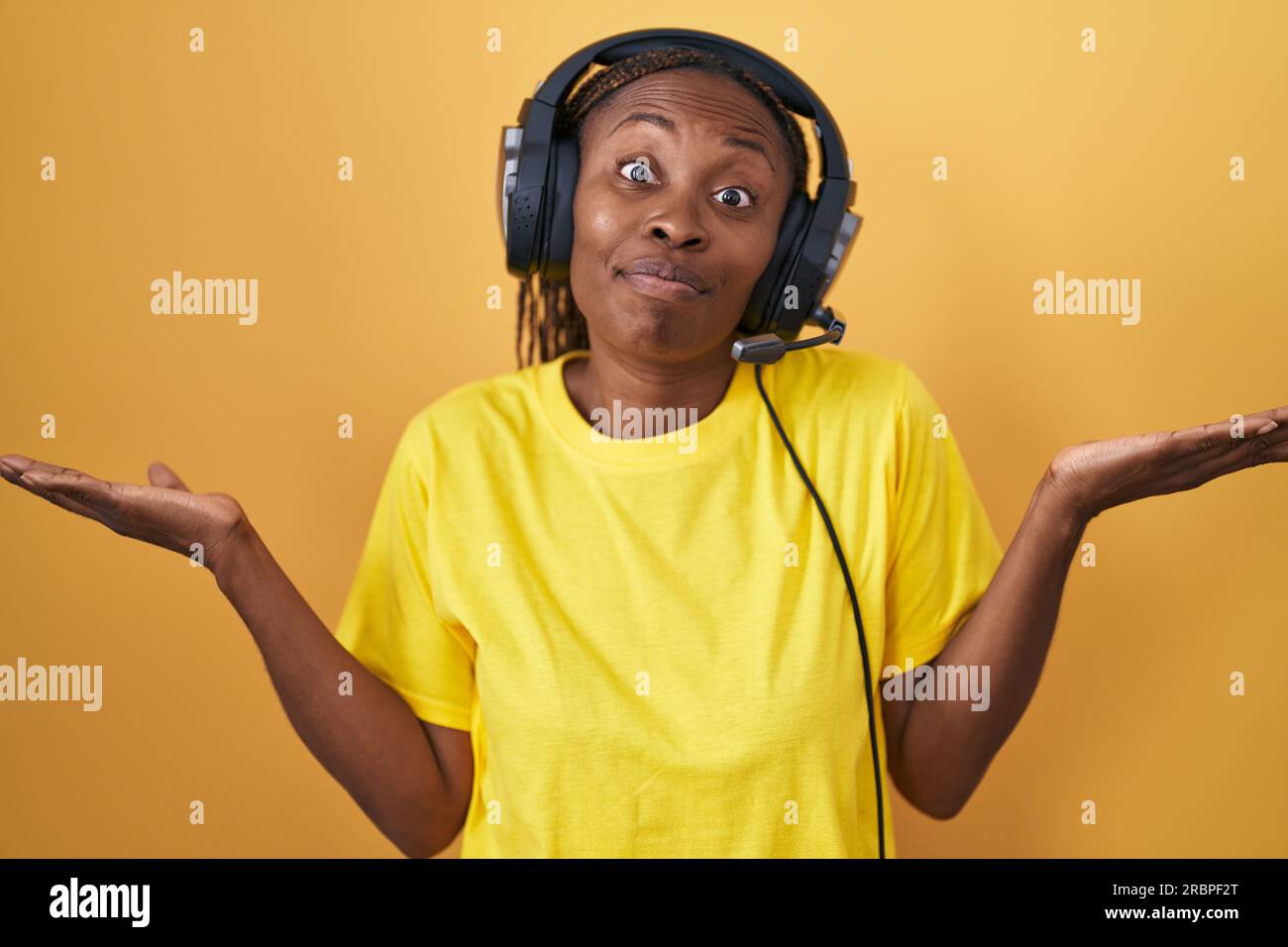 African american woman listening to music using headphones clueless and ...