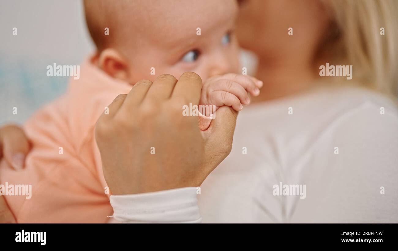 Mother and daughter hugging each other holding hand at home Stock Photo - Alamy