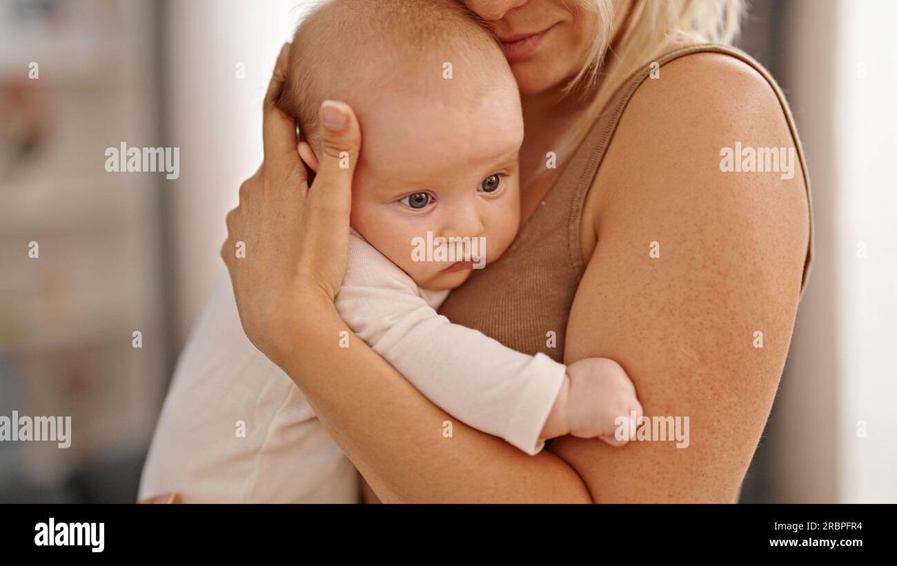 Mother and daughter hugging each other standing at home Stock Photo - Alamy