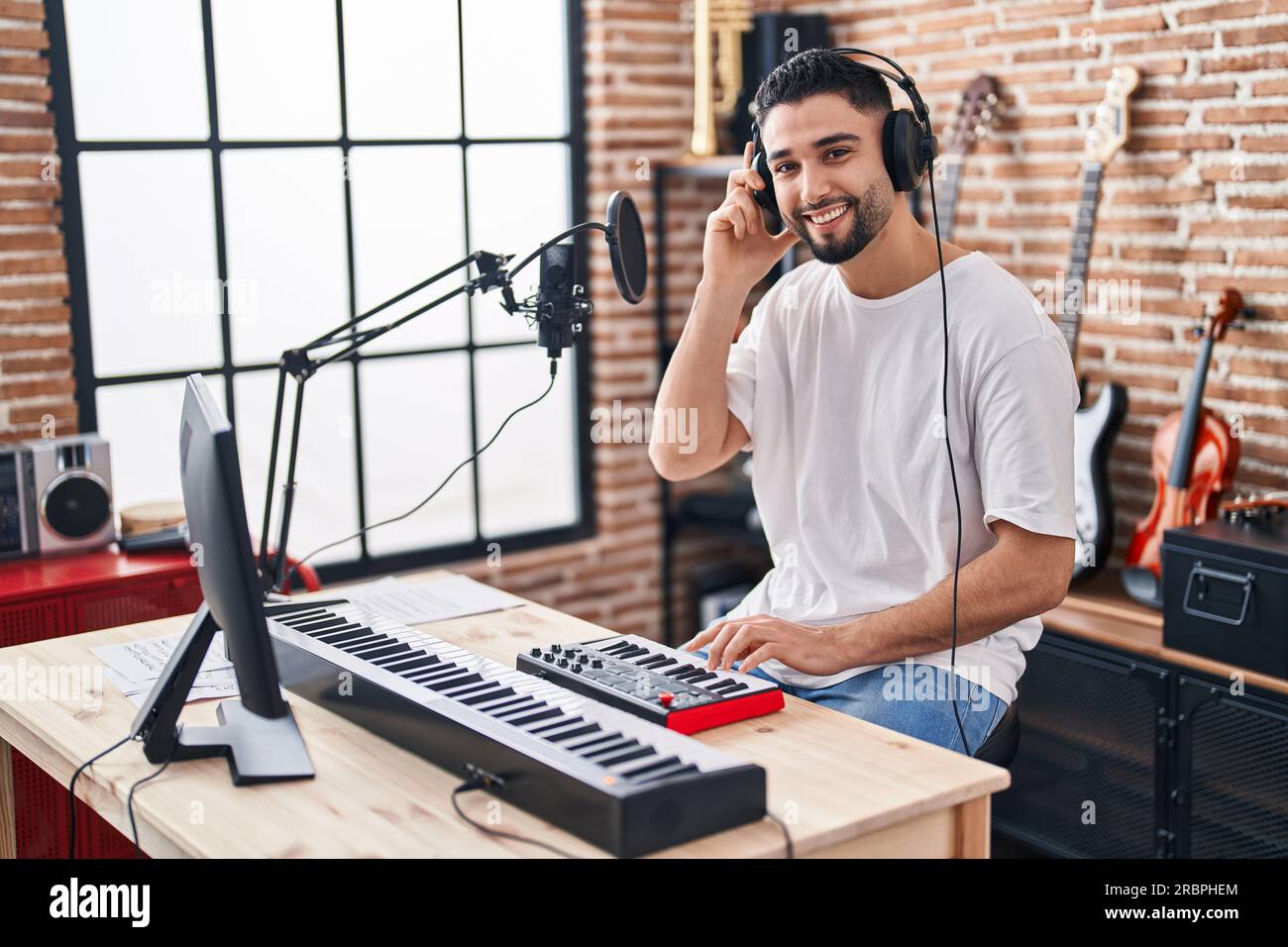 Young arab man musician playing piano keyboard at music studio Stock ...