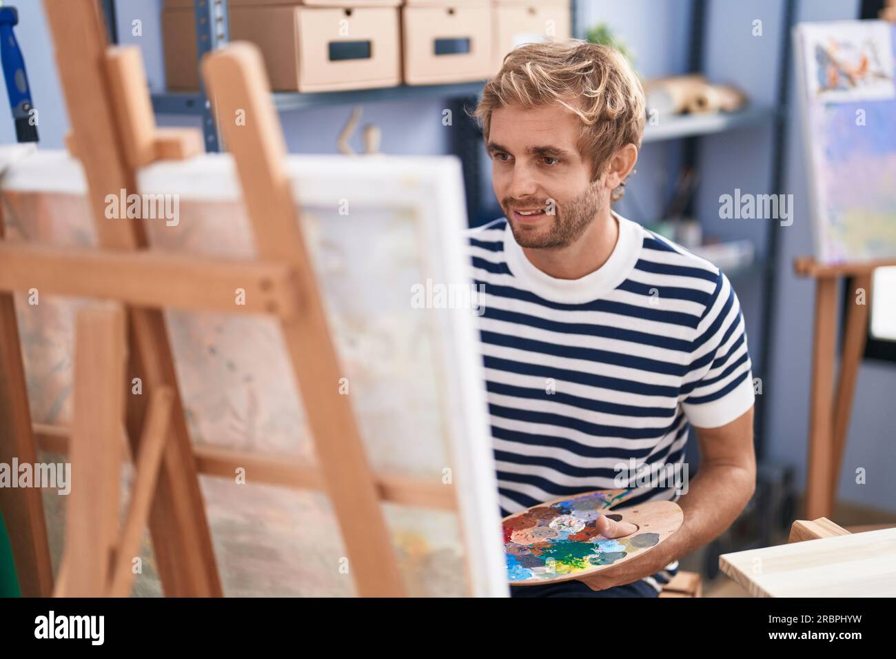 Young man artist smiling confident drawing at art studio Stock Photo ...