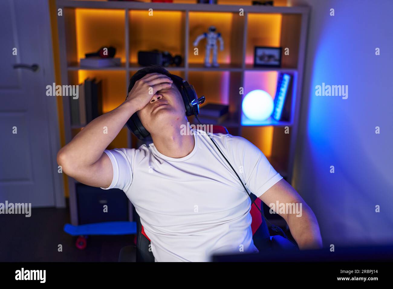 Young chinese man streamer stressed using computer at gaming room Stock ...