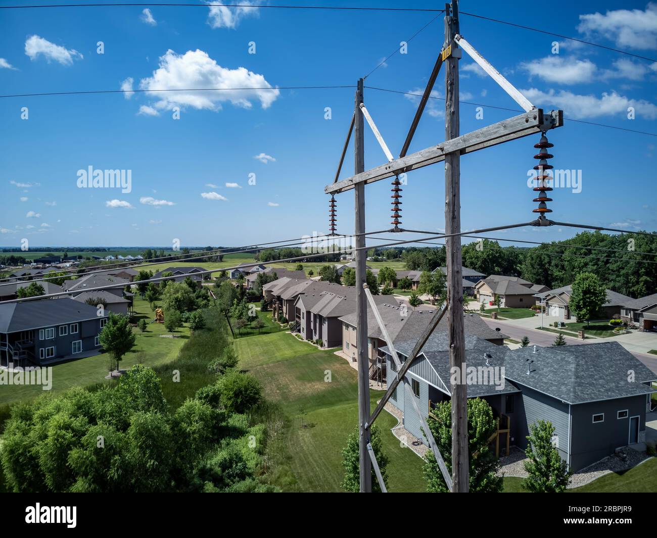 Drone aerial view of high voltage power lines through a residential ...