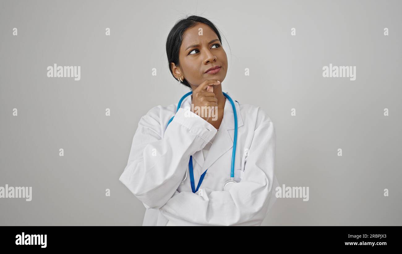 African american woman doctor standing with doubt expression thinking ...