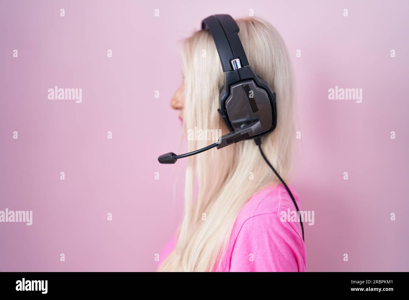 Caucasian woman listening to music using headphones looking to side ...