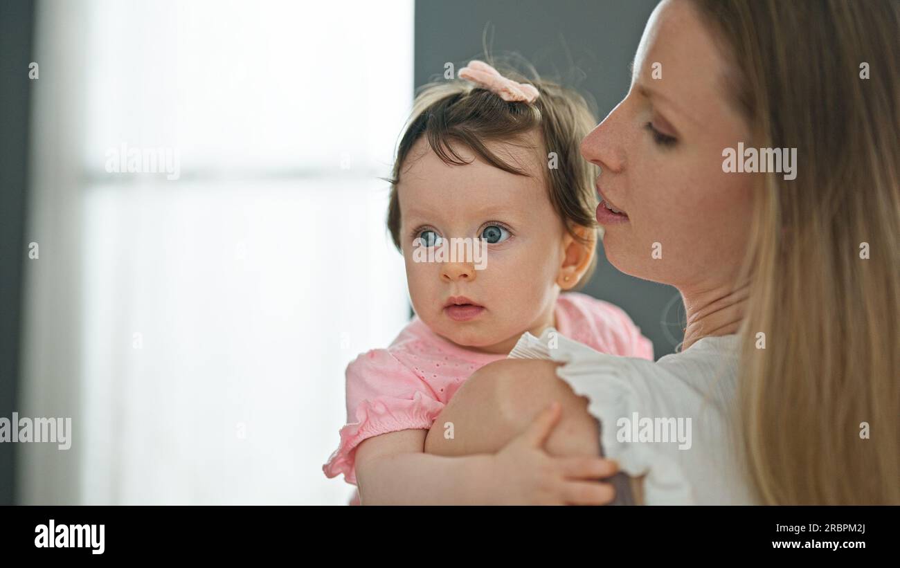 Mother and daughter hugging each other at home Stock Photo - Alamy