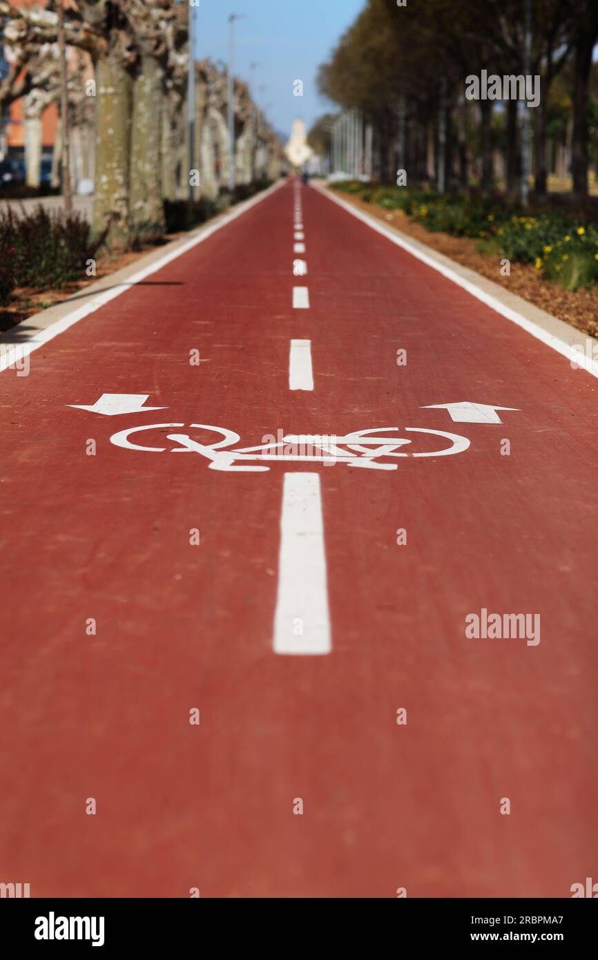 New marking bike path. White bicycle symbol and two oposite arrows on ...