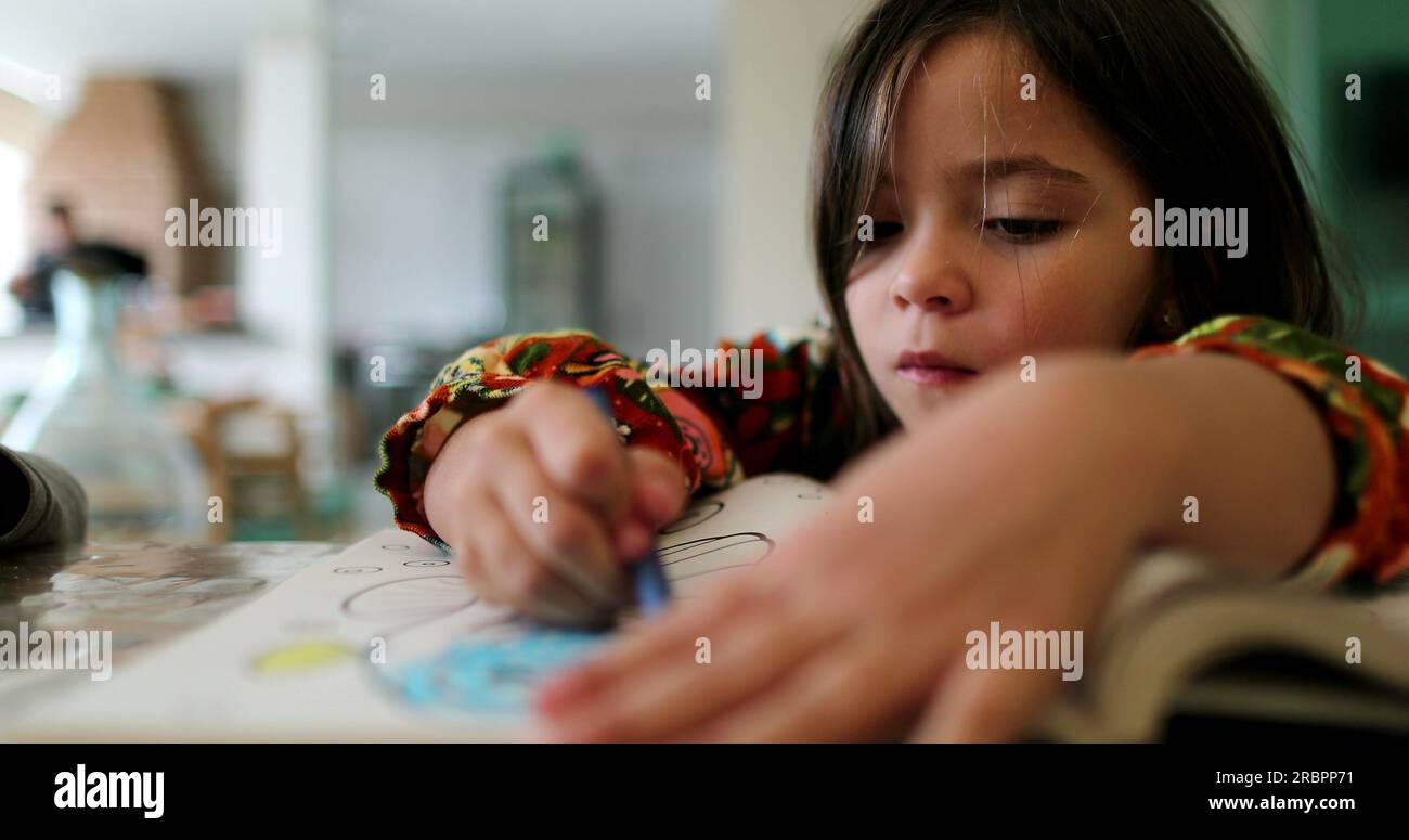 Little girl drawing on paper child draws with color crayon Stock Photo ...