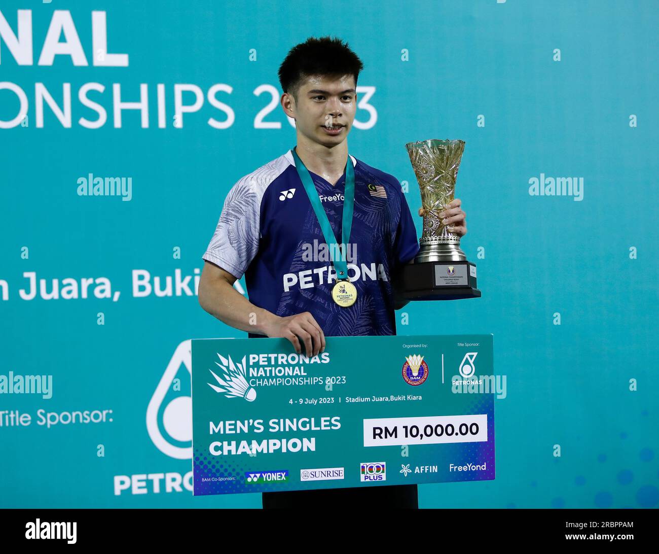 Leong Jun Hao of BAM poses with his medals and trophy at the podium ...