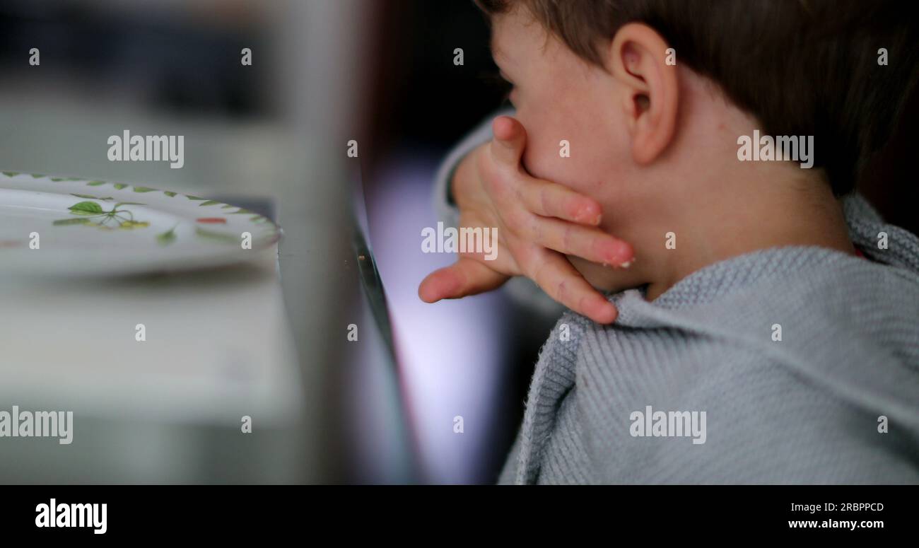 Child wiping mouth with hand kid rubbing face Stock Photo - Alamy