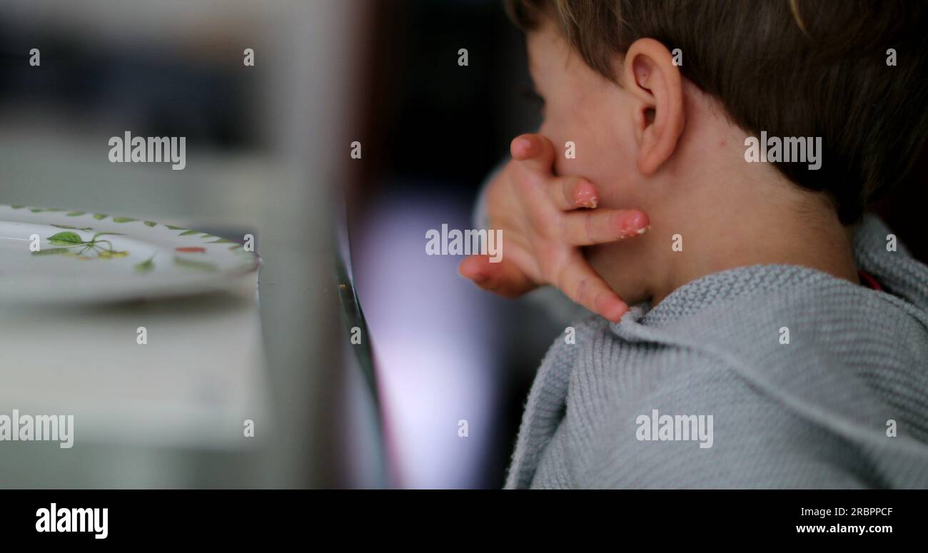 Child wiping mouth with hand kid rubbing face Stock Photo - Alamy