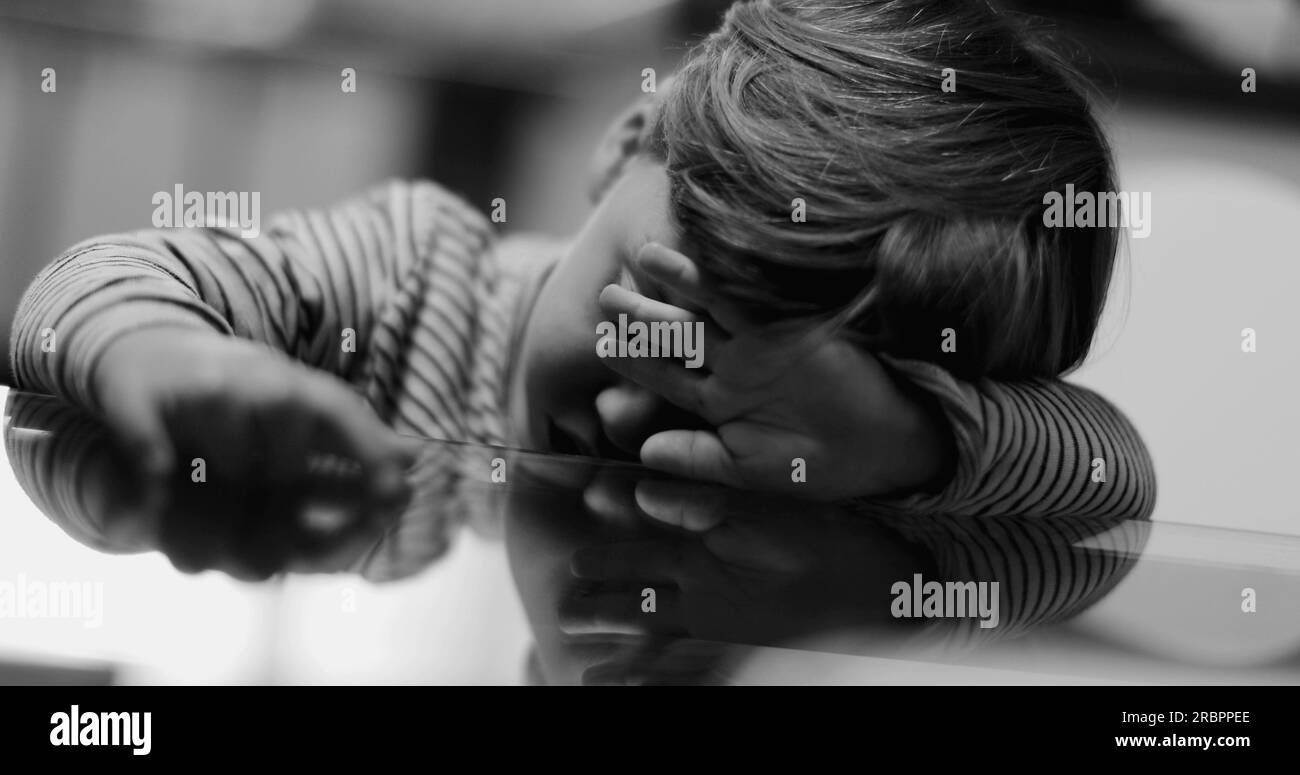 Depressed child covering face trauma concept in monochrome Stock Photo ...