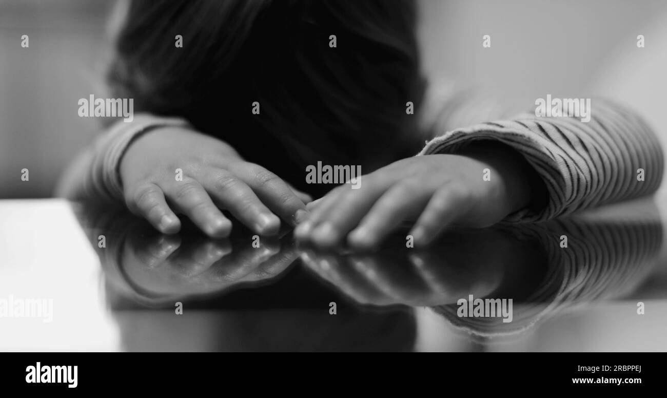 Depressed child covering face trauma concept in monochrome Stock Photo ...