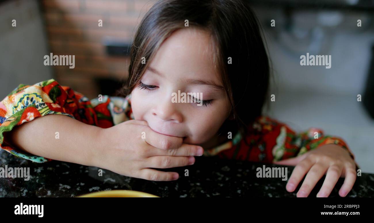 Child eating cashew nuts from bowl Stock Photo - Alamy