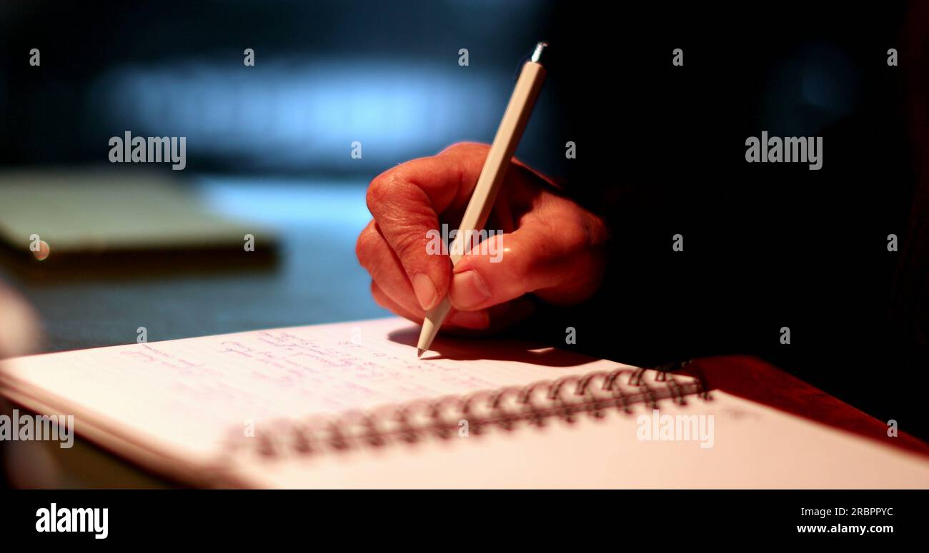 Hand holding pen writing notes closeup person taking notes Stock Photo ...