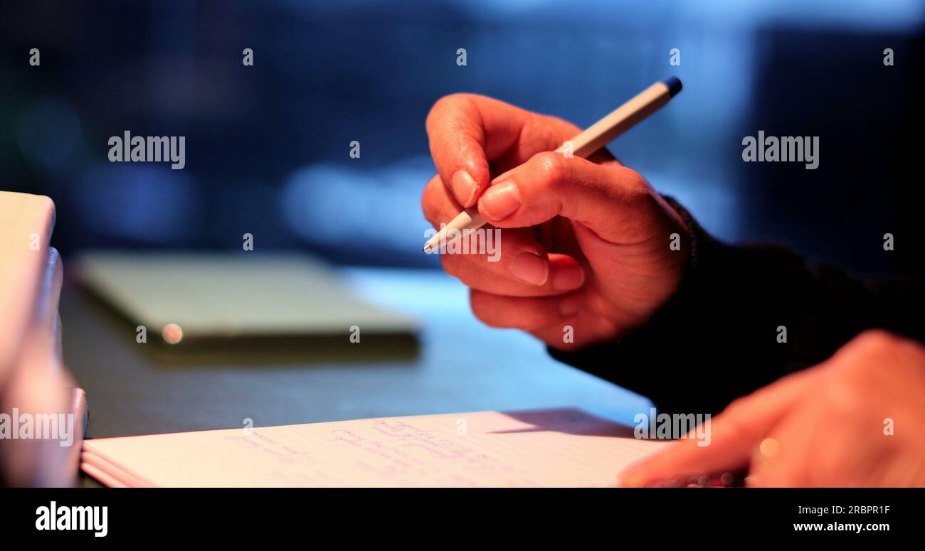 Hand holding pen writing notes person thinking Stock Photo - Alamy