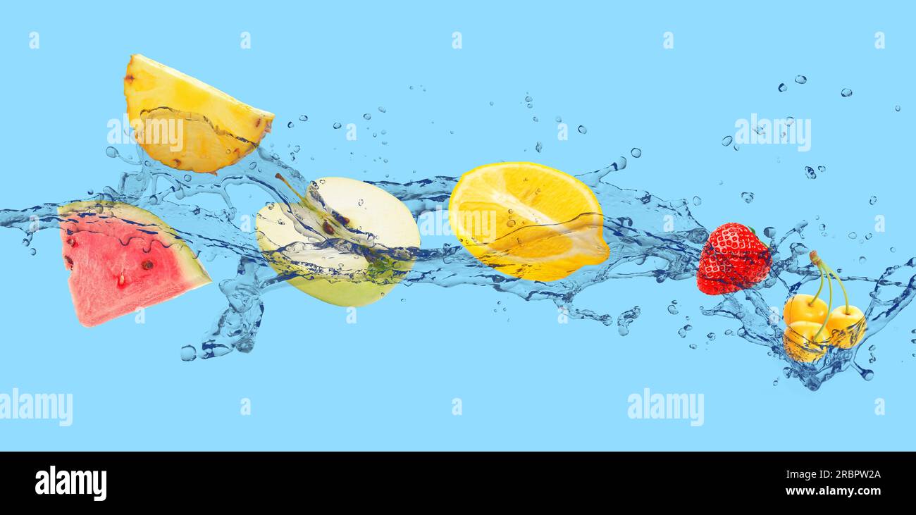 Fresh fruits and water splash on light blue background Stock Photo - Alamy