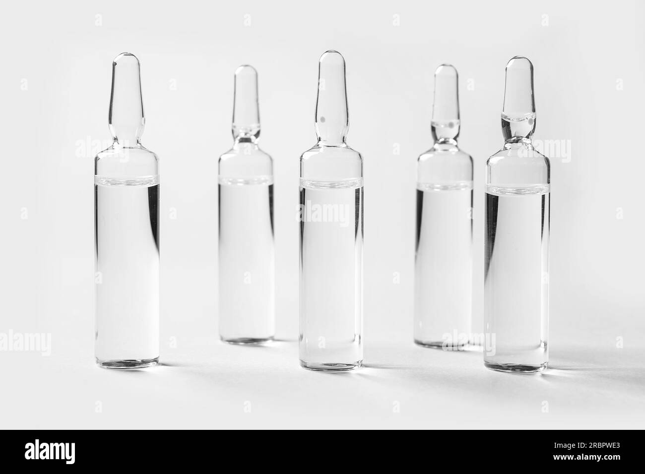 Medical ampules on light background Stock Photo - Alamy