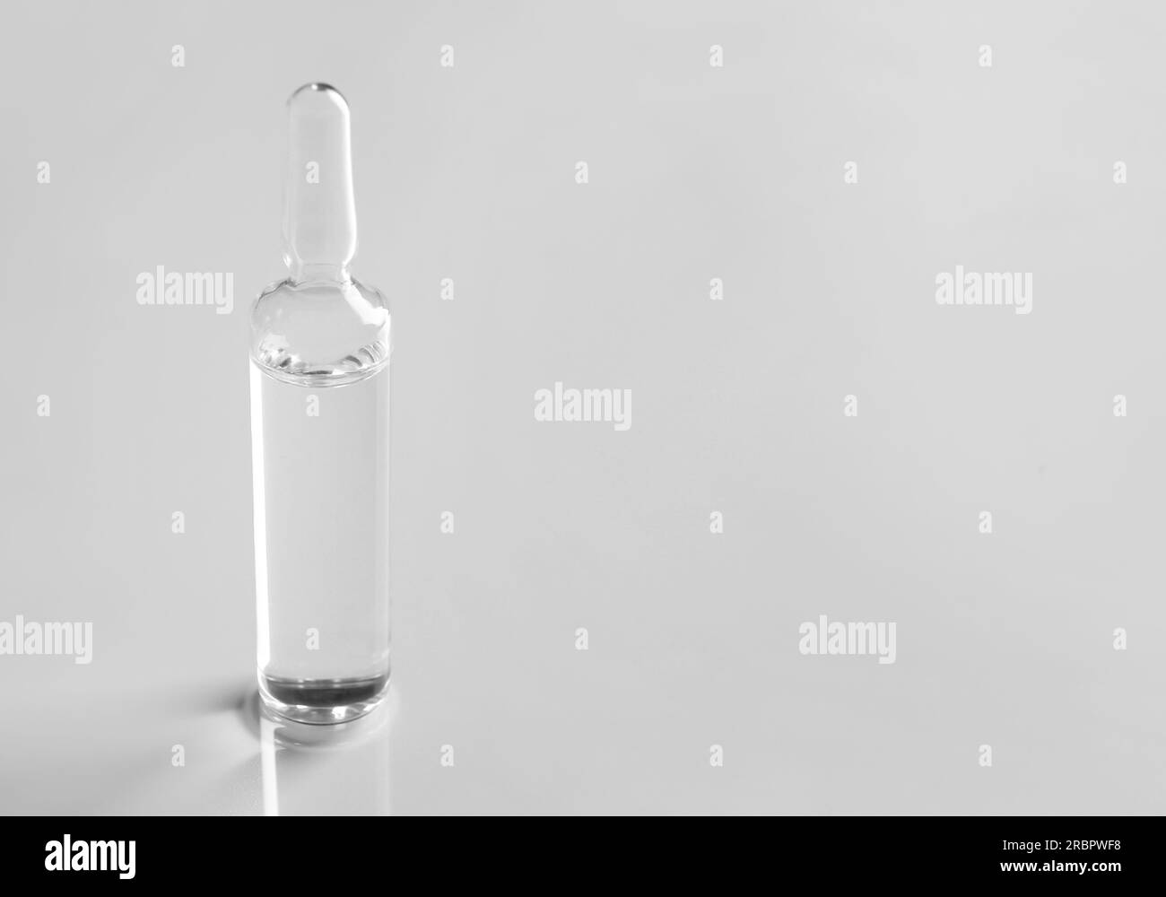 Medical ampule on light background Stock Photo - Alamy