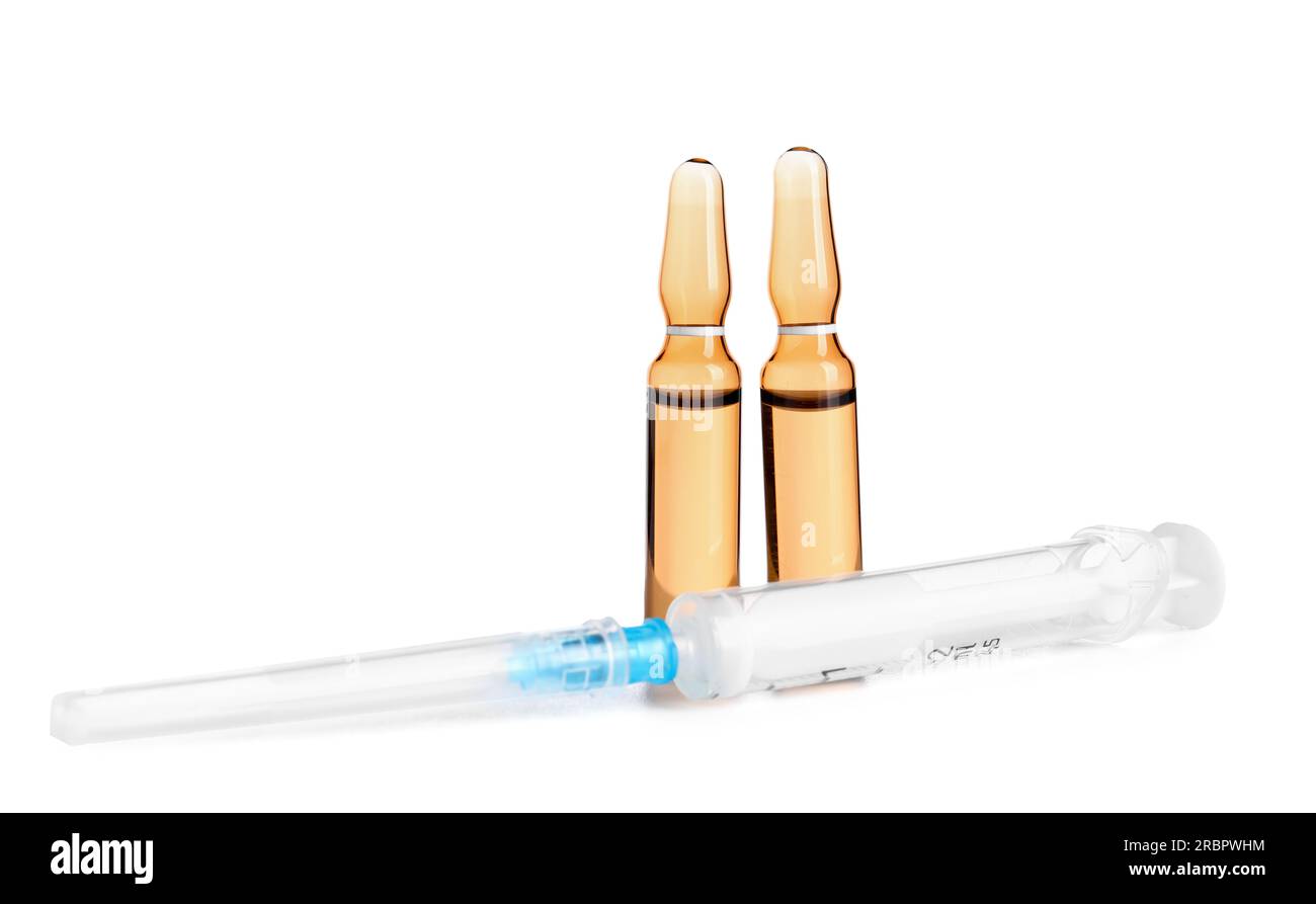 Ampules and syringe with needle on white background Stock Photo - Alamy