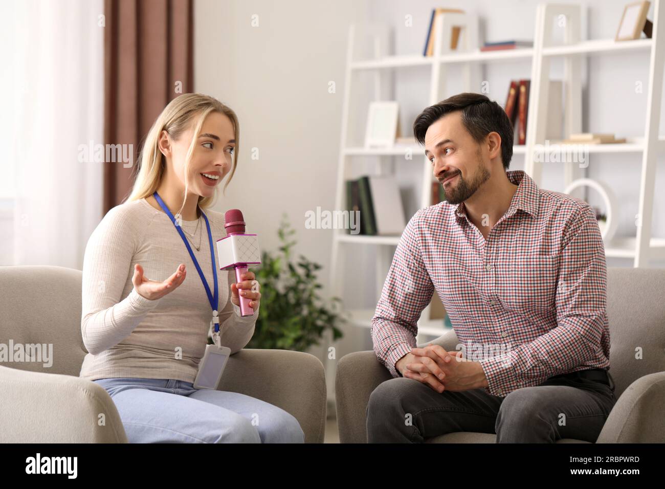 Female journalist with microphone having an interview with man in ...