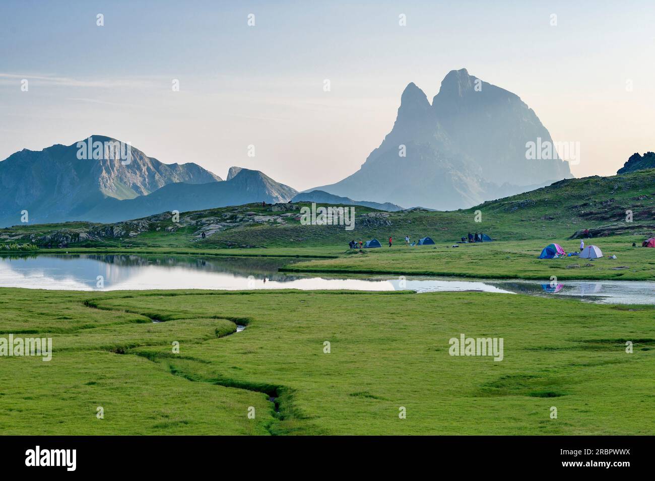 Mountain lake Ibon de Anayet with several tents and Pic du Midi in the background, Ibon de ...