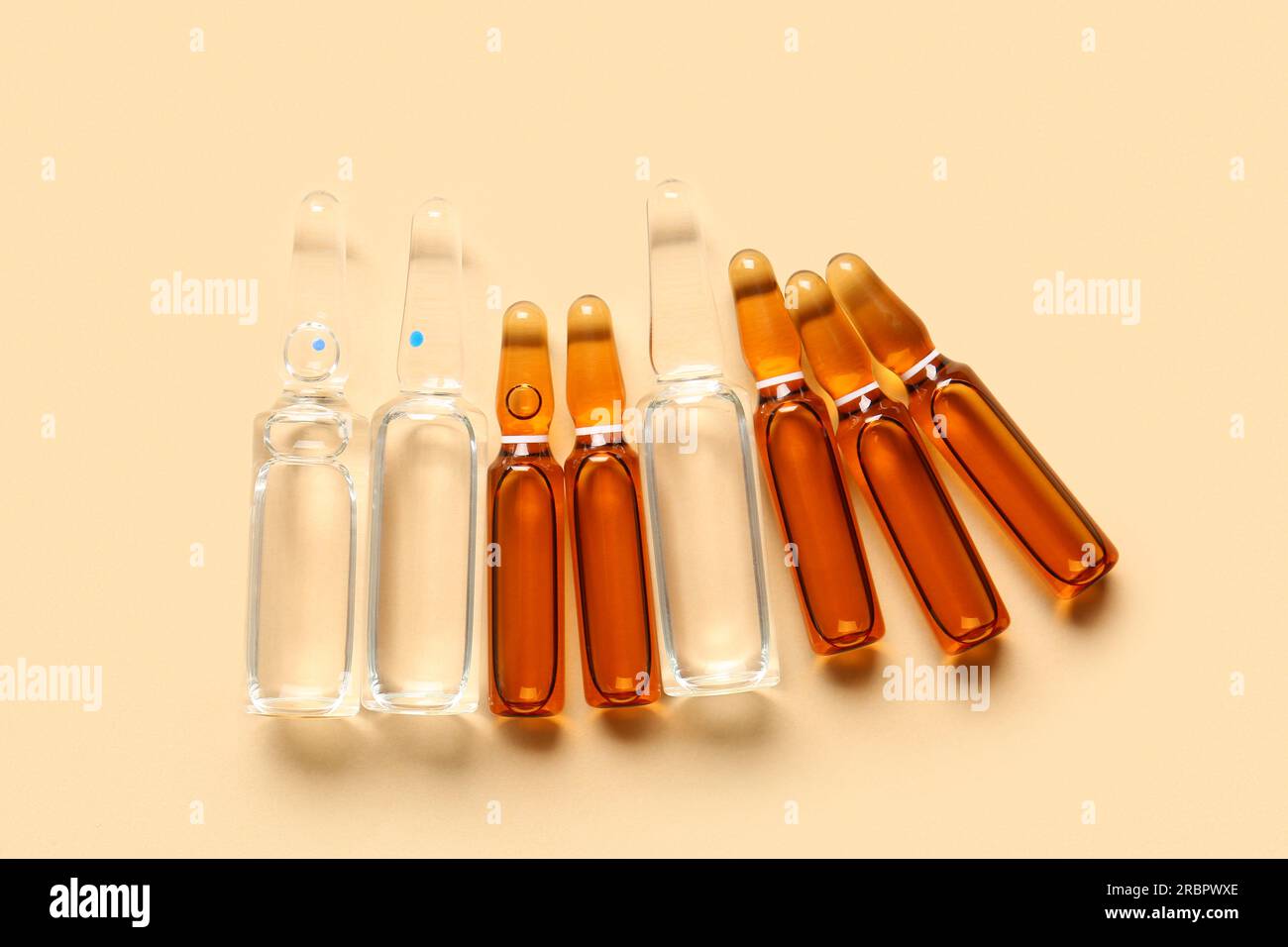 Glass medical ampules on beige background Stock Photo - Alamy