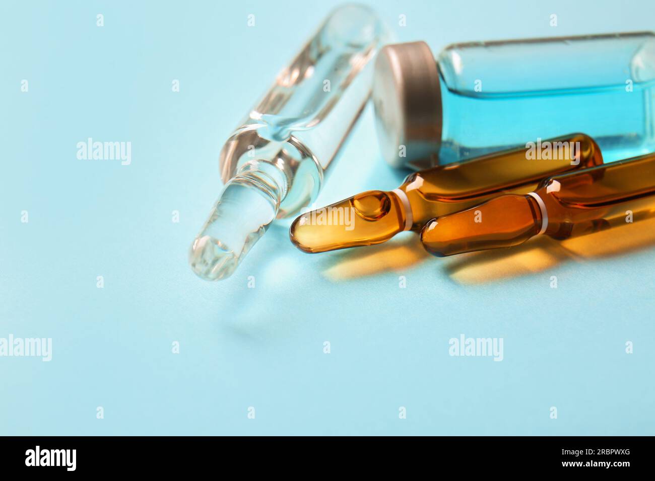 Medical ampules and bottle with medicines on blue background Stock ...