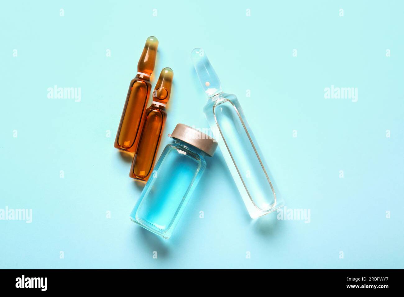 Medical ampules and bottle with medicines on blue background Stock ...
