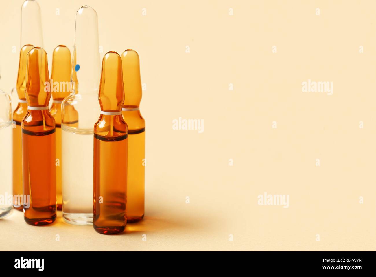 Glass medical ampules on beige background Stock Photo - Alamy