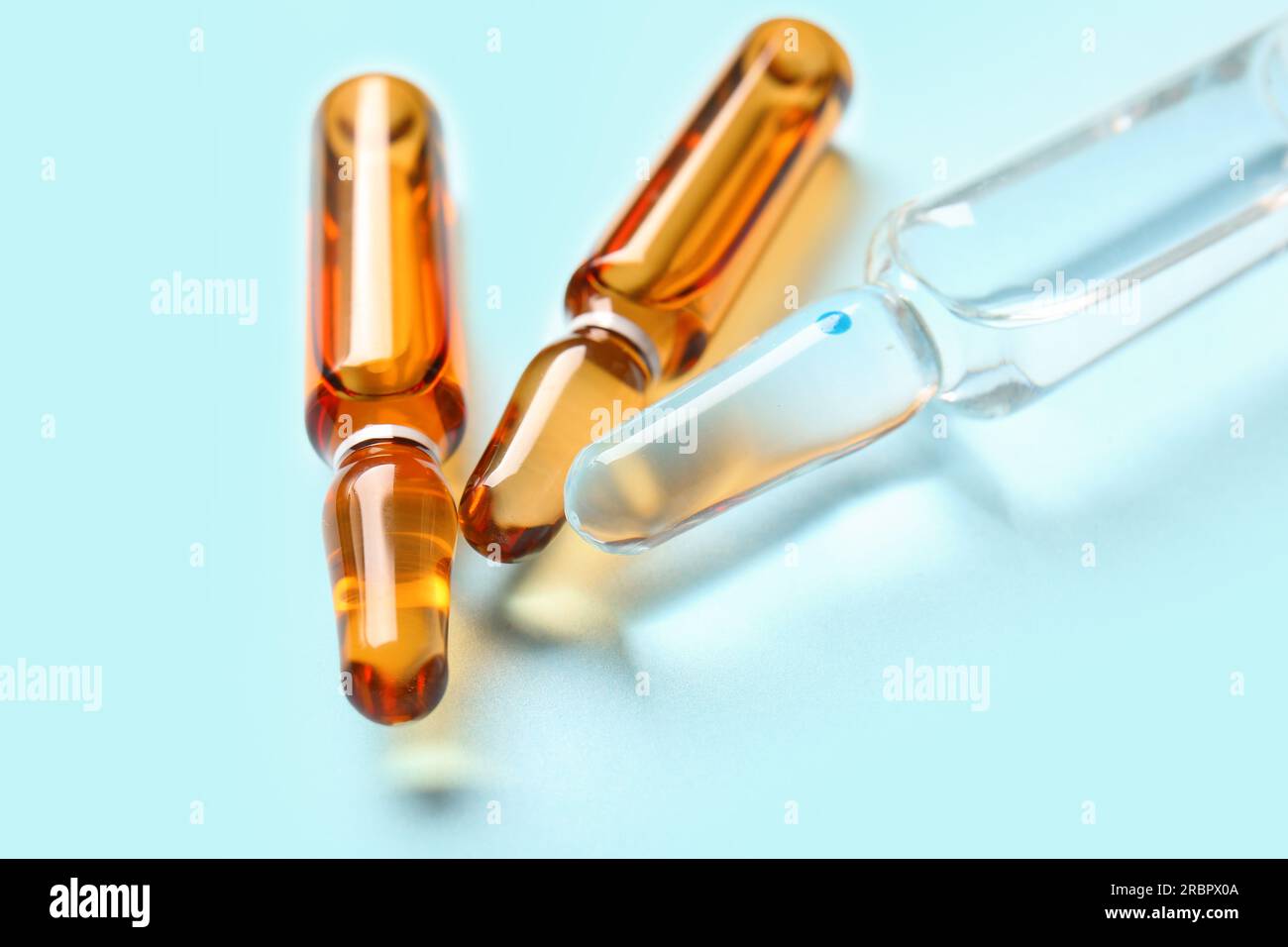 Glass medical ampules on blue background Stock Photo - Alamy