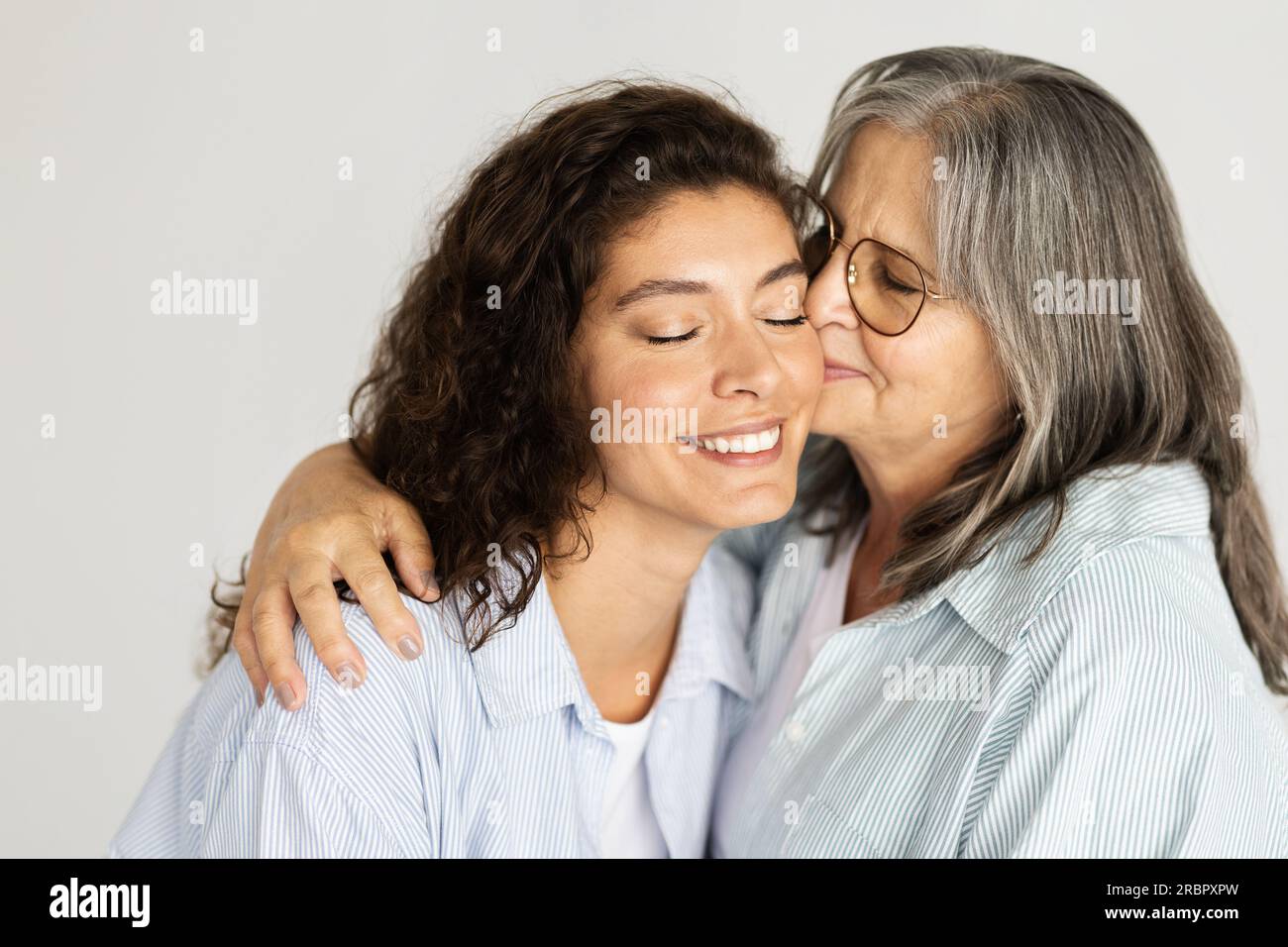 Happy european elderly woman hugging, kissing millennial lady Stock ...
